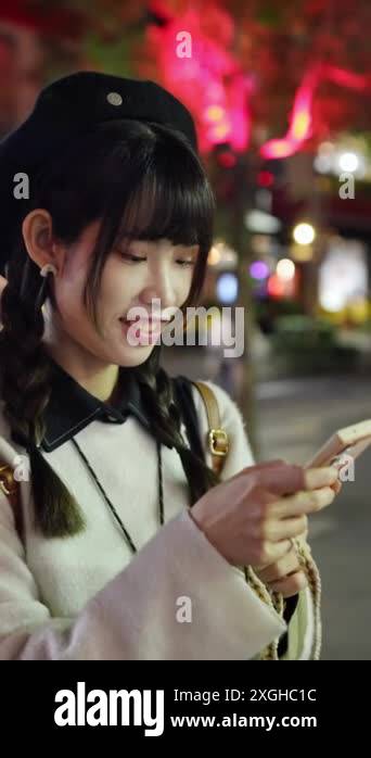 Vertical slow-motion video of a young and cute Taiwanese woman in her ...