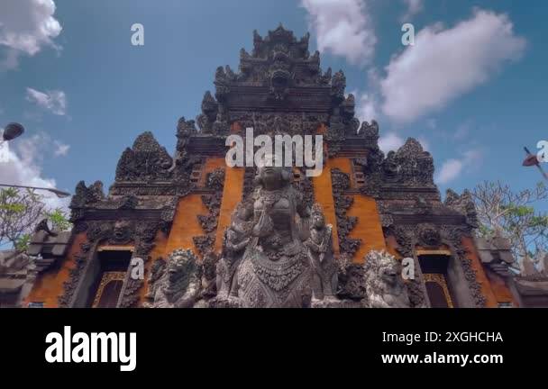 Intricate Balinese temple with detailed carvings and statues against a ...