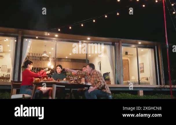 Happy family holding glowing sparkler in holiday celebration party at ...