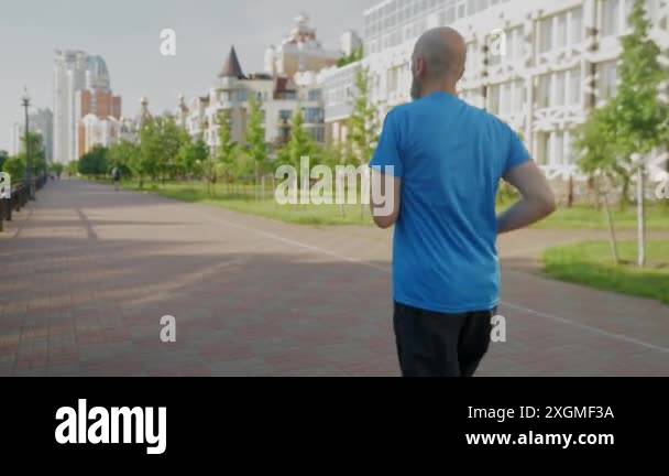 Rear view of active determined fitness mature male athlete in sports ...