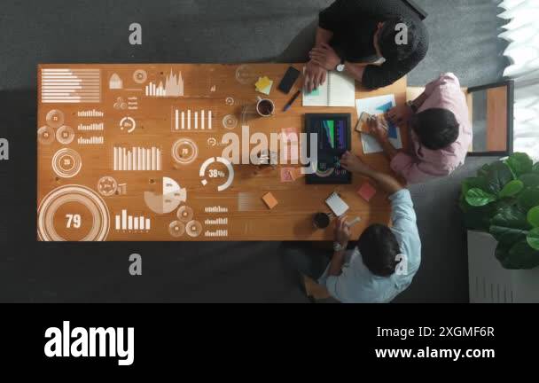 Top down view of team discuss about financial graph from tablet at meeting room. Smart ...