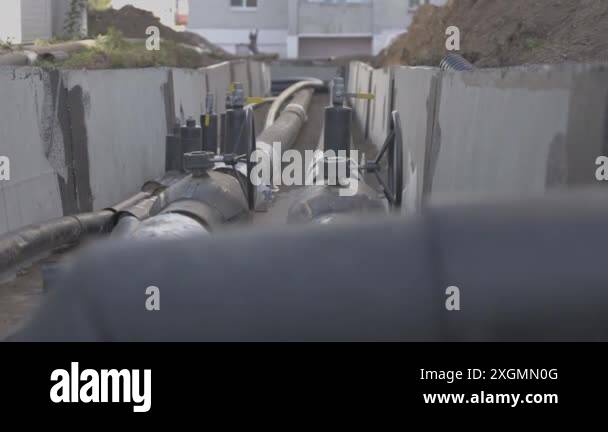 Water supply system in trench with concrete walls near industrial ...