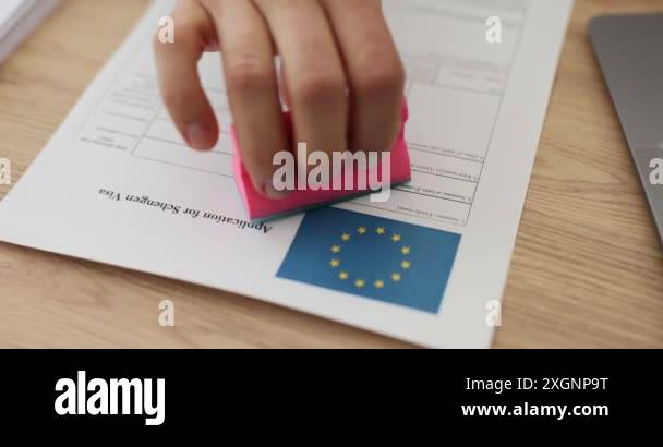 Hand of inspector putting stamp approved on schengen visa application ...