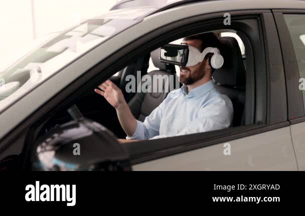 Businessman uses virtual reality headset while sitting inside vehicle ...