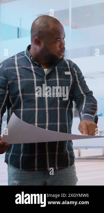 Vertical Video Real estate agent and clients discussing detailed ...