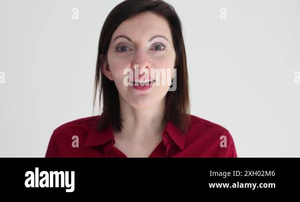 Woman covers mouth with palms in astonishment on gray background. Lady ...