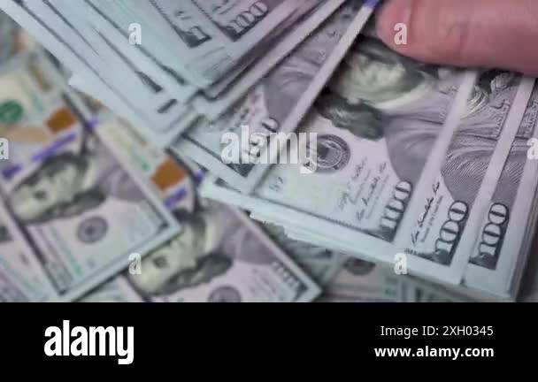 Mans fingers count a thick stack of American dollars. Concept of ...