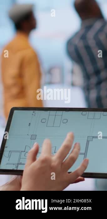 Vertical Video Real Estate Agent And Client Evaluating Blueprints And