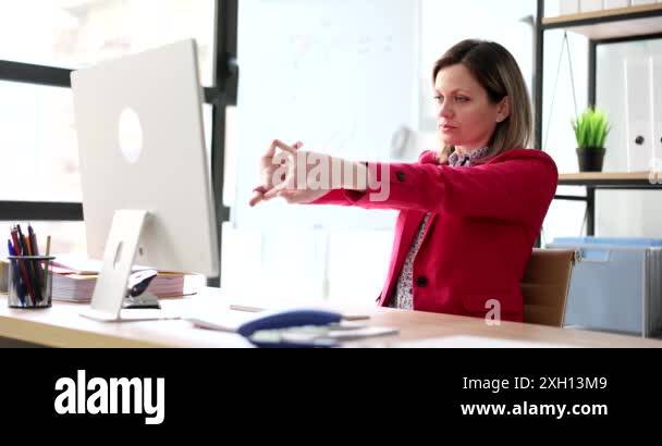 Overworked employee stretches arms continuing to type on keyboard of ...