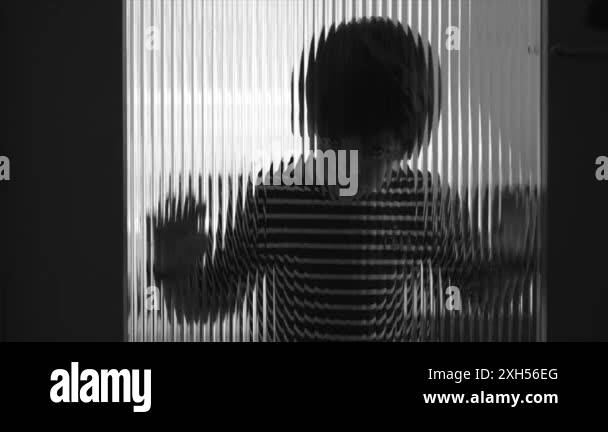 Young Boy Looking Sad And Isolated, Trapped Behind A Glass Door With ...