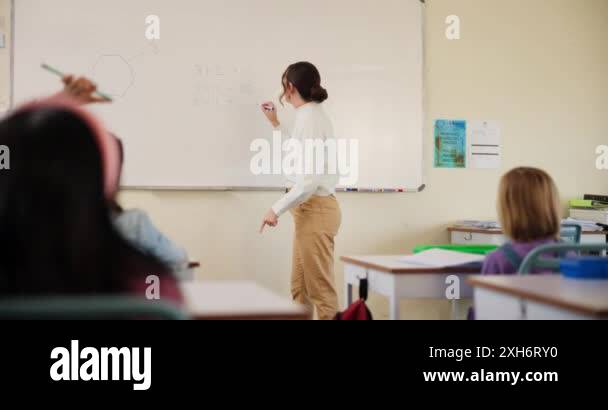 Woman, math and writing on whiteboard in classroom for learning ...