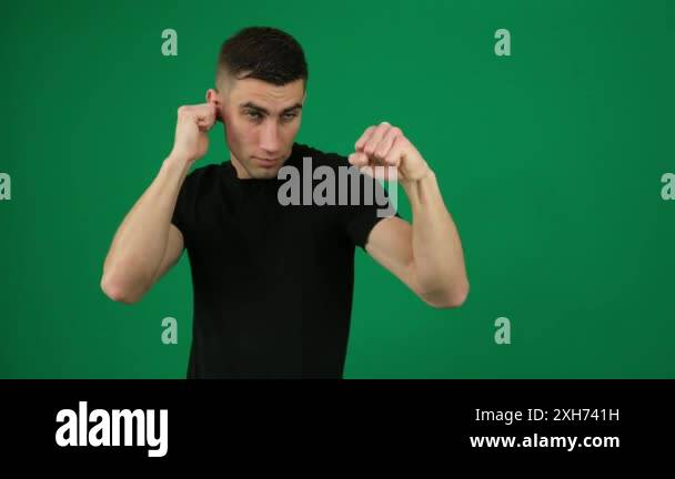 Boxing pose guy. emotions of a handsome man guy on a green background ...