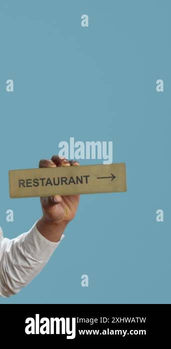 Vertical Video Doorman bellhop showing the restaurant direction with a ...