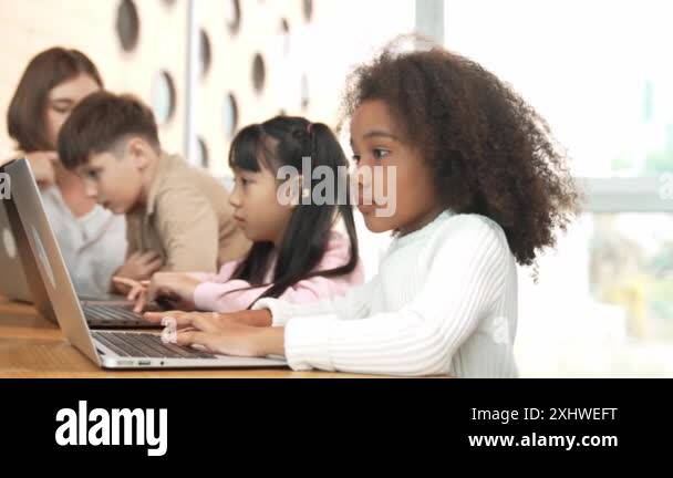 African girl play laptop with diverse friend learning prompt at STEM technology class ...