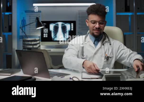 Medium shot of young positive radiologist with stethoscope in glasses ...