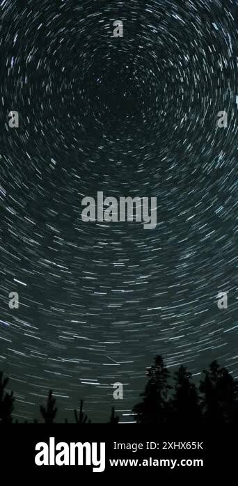 Time lapse of Star trails in the night sky. Stars move around a polar ...