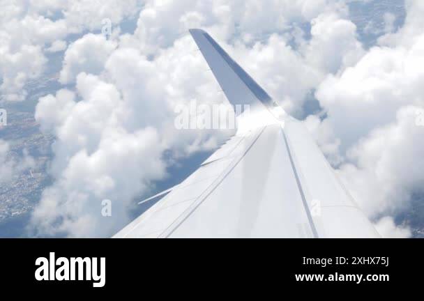 view through airplane aircraft window with wing view flying making a ...