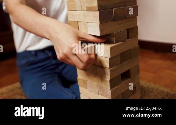 Tower game. Happy family with kid playing board games outdoors in the ...