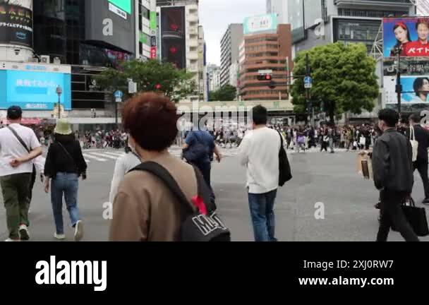 Tokyo, Japan- 12 May 2024: People cross the busy intersection in Shibuya, Tokyo. It is one of ...