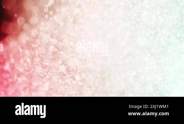 A dynamic display of small, sparkling particles creates a burst of ...