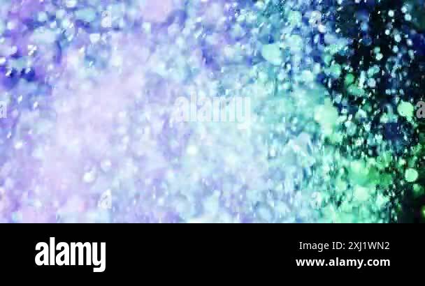 Numerous bright particles burst and float against a dark backdrop. The ...