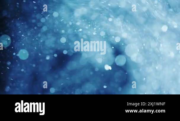 Bright, predominantly blue particles swirl and move across a dark ...