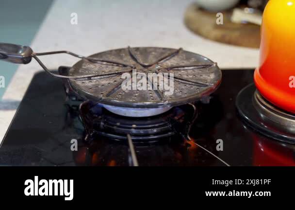 Making Arepas: Traditional Cooking. Hands roast an arepa on a stove ...