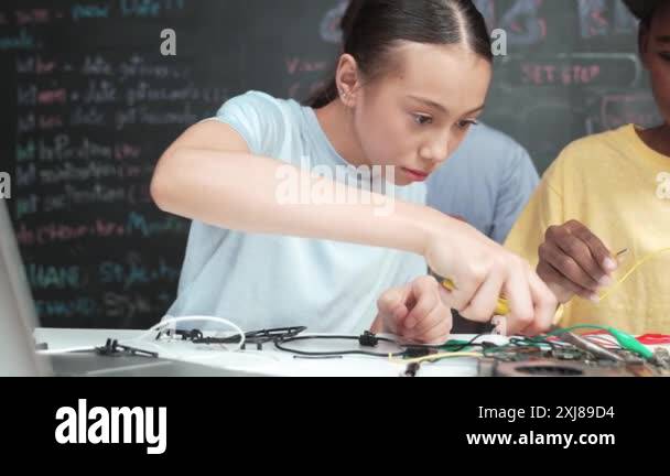 Diverse student using electronic tool fixing board while caucasian ...