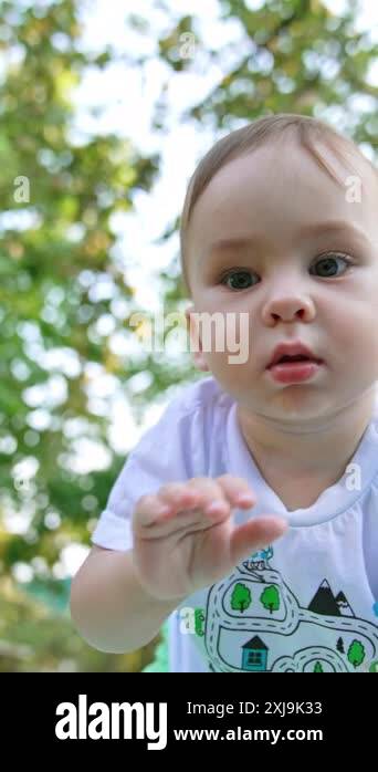 Curious little baby boy exploring the camera and clapping by it. Low ...