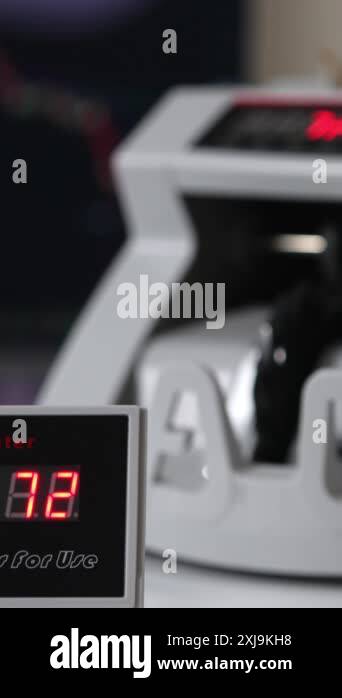 White compact money-counting machine working. Fifty euro banknotes ...