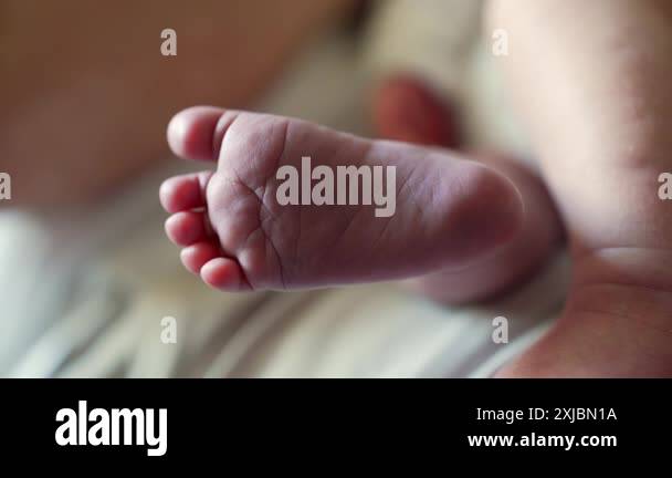 Close-up of newborn baby's foot, highlighting the tiny wrinkles and ...