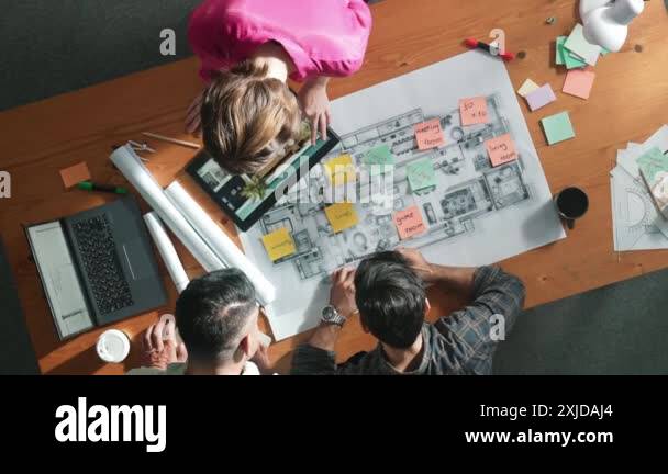 Top down aerial view of civil engineer hold project plan while design ...