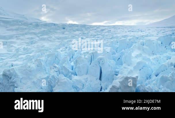 Calving blue glacier close up in Perito Moreno. Snow mass wall towering ...