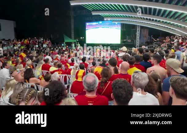 Handheld Arc Shot of crowd of Spanish supporters watching the live euro ...