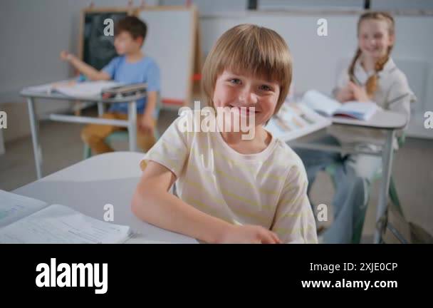 Portrait cheerful pupil boy looking camera at school. Happy smiling kid ...