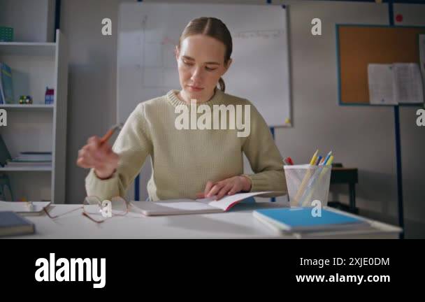 Positive girl working school at class room closeup. Calm woman teacher ...