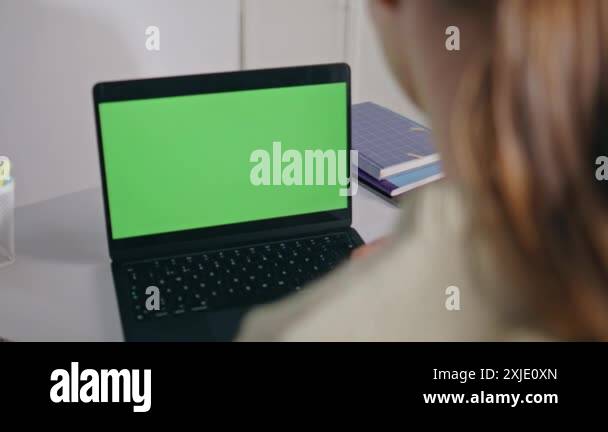 Lady teacher looking greenscreen laptop in school office closeup ...