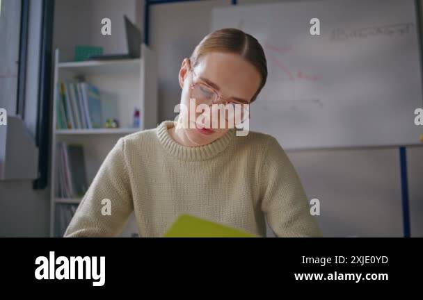 Serious teacher working classroom alone closeup. Young professional ...