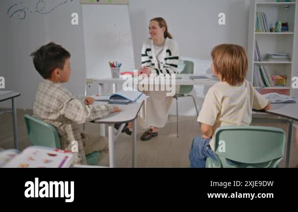 Active pupils studying together at elementary school. Smiling boys ...