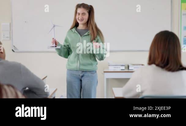 Girl, windmill and talk in science classroom for presentation ...