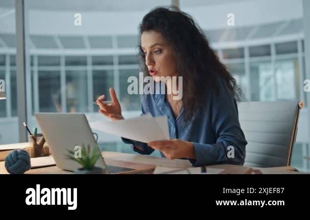 Boss arguing virtual meeting in office. Focused woman analyzing documents talk remote colleague ...