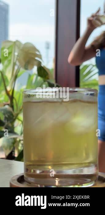 girl drinks a cold drink after the gym. Woman drinking water from bottle after gym outdoor ...