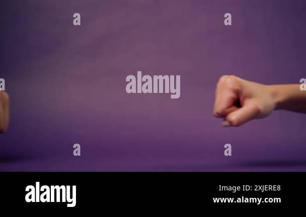 Beautiful female hand on isolated on purple background two hands fist ...