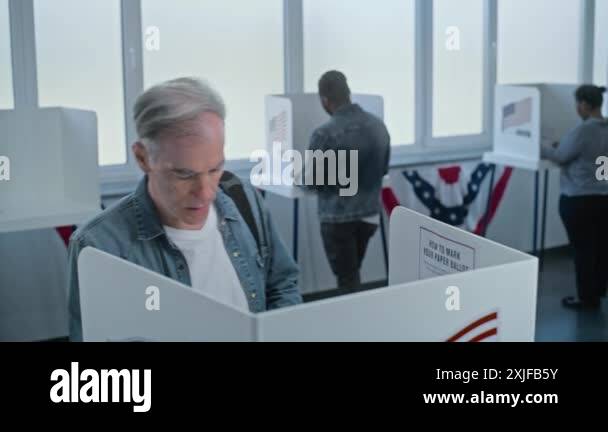 Mature man comes to vote in booth in polling station office. National ...