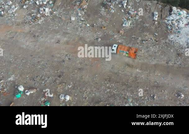 Aerial shot of big rubbish pile lying among field in countryside ...