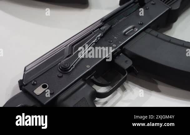 Machine guns and machine guns at a military weapons show. Black modern ...