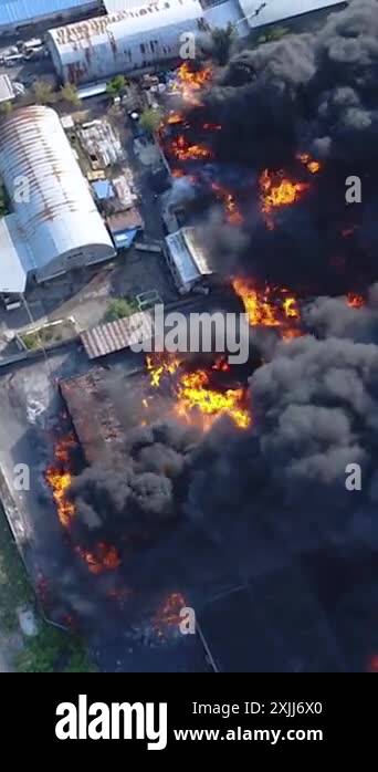 Drone video of a large fire warehouse. Thick black smoke in the sky ...