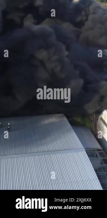 Drone video of a large fire warehouse. Thick black smoke in the sky ...