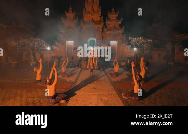 A group of dancers performing a traditional dance in front of an ...