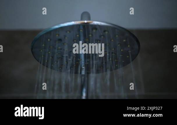 Drops and flow of water. Shower head, close-up. Water flows in the ...